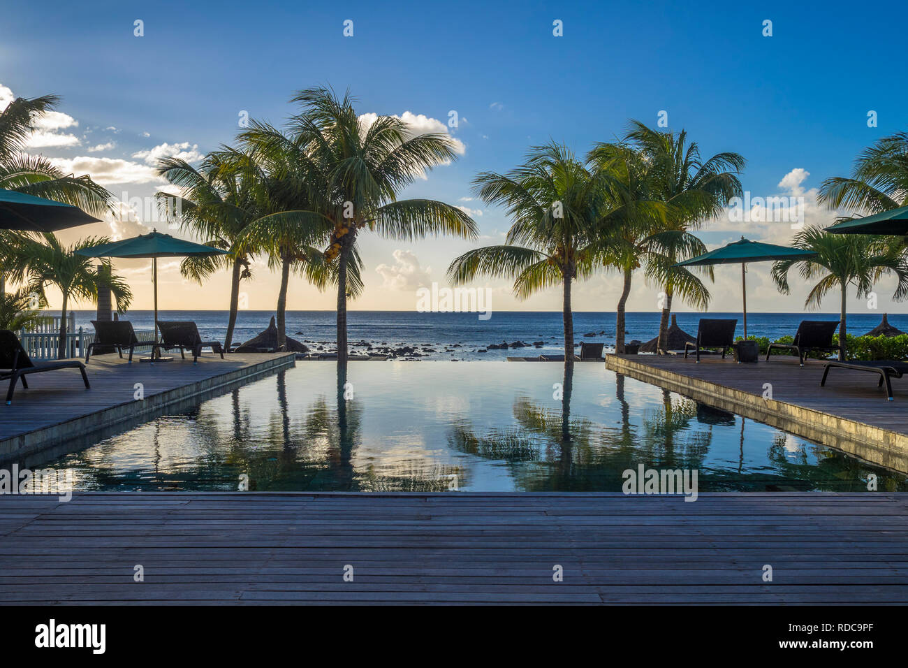 Infinity pool at resort in Mauritius during sunset Stock Photo - Alamy