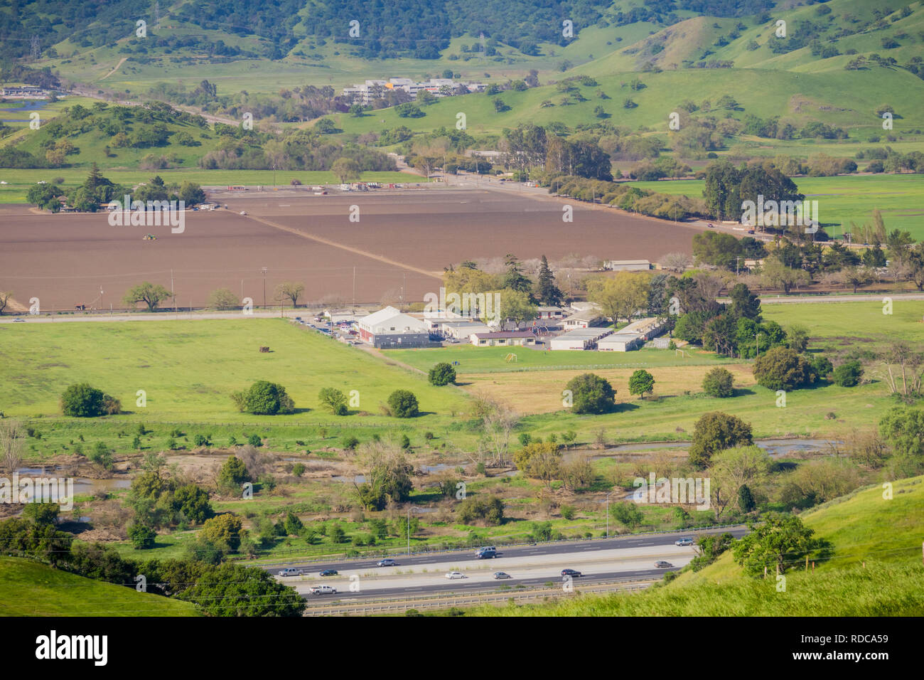Aerial view of agricultural fields and farm building, mountain ...
