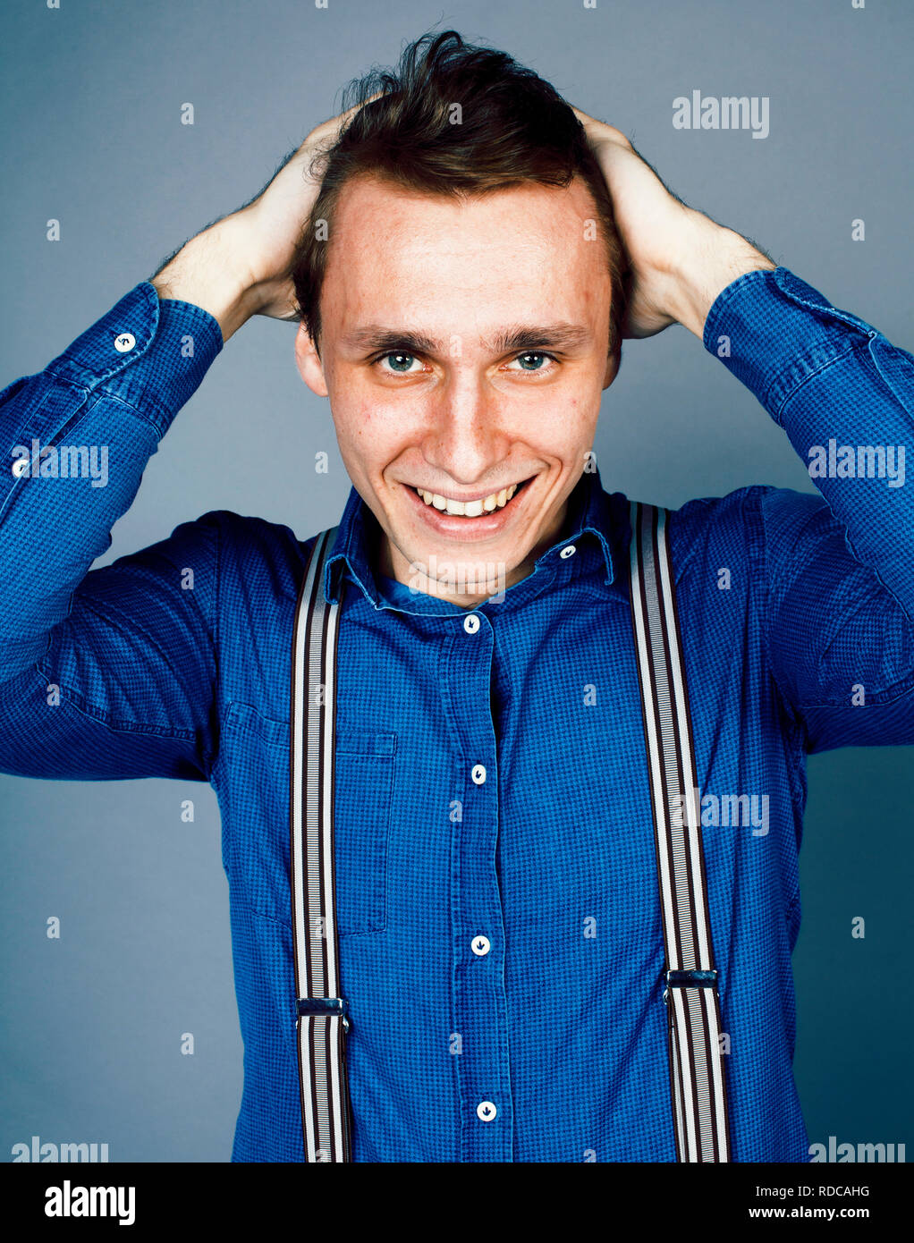 young goofy man with pimples pointing in studio Stock Photo - Alamy