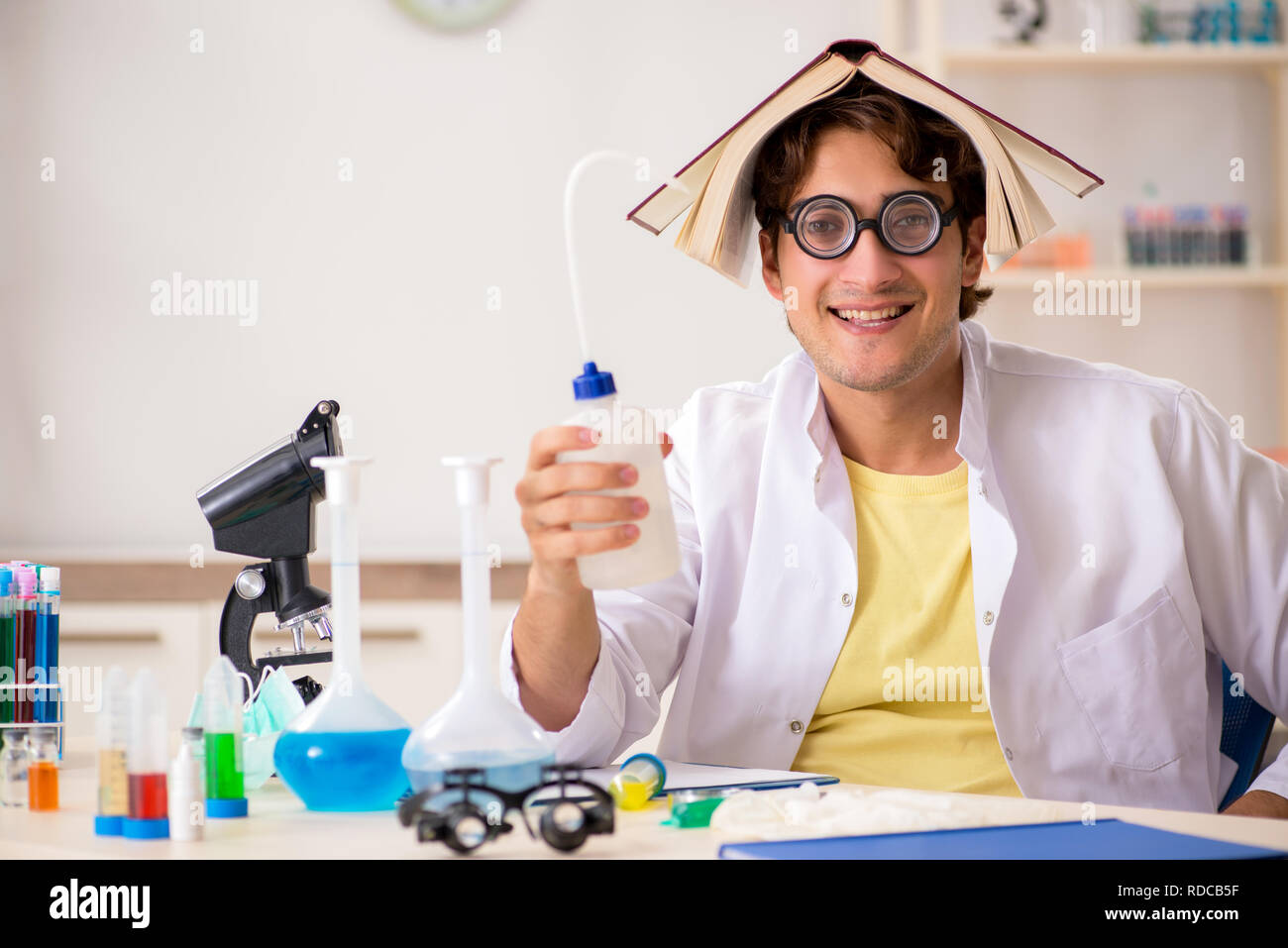 Funny crazy chemist doing experiments and tests Stock Photo - Alamy