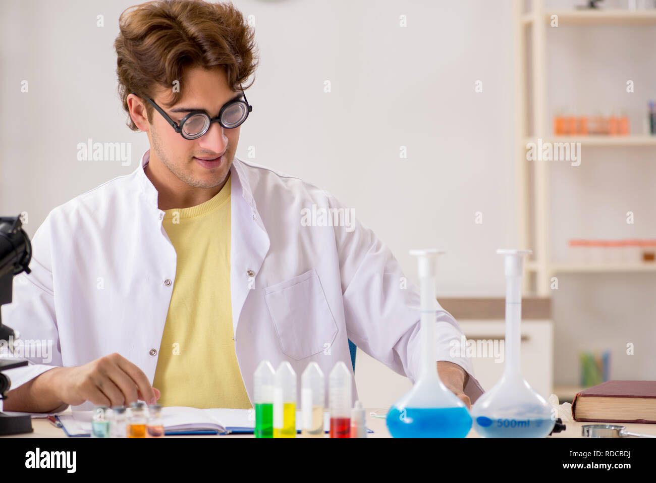 Funny crazy chemist doing experiments and tests Stock Photo - Alamy