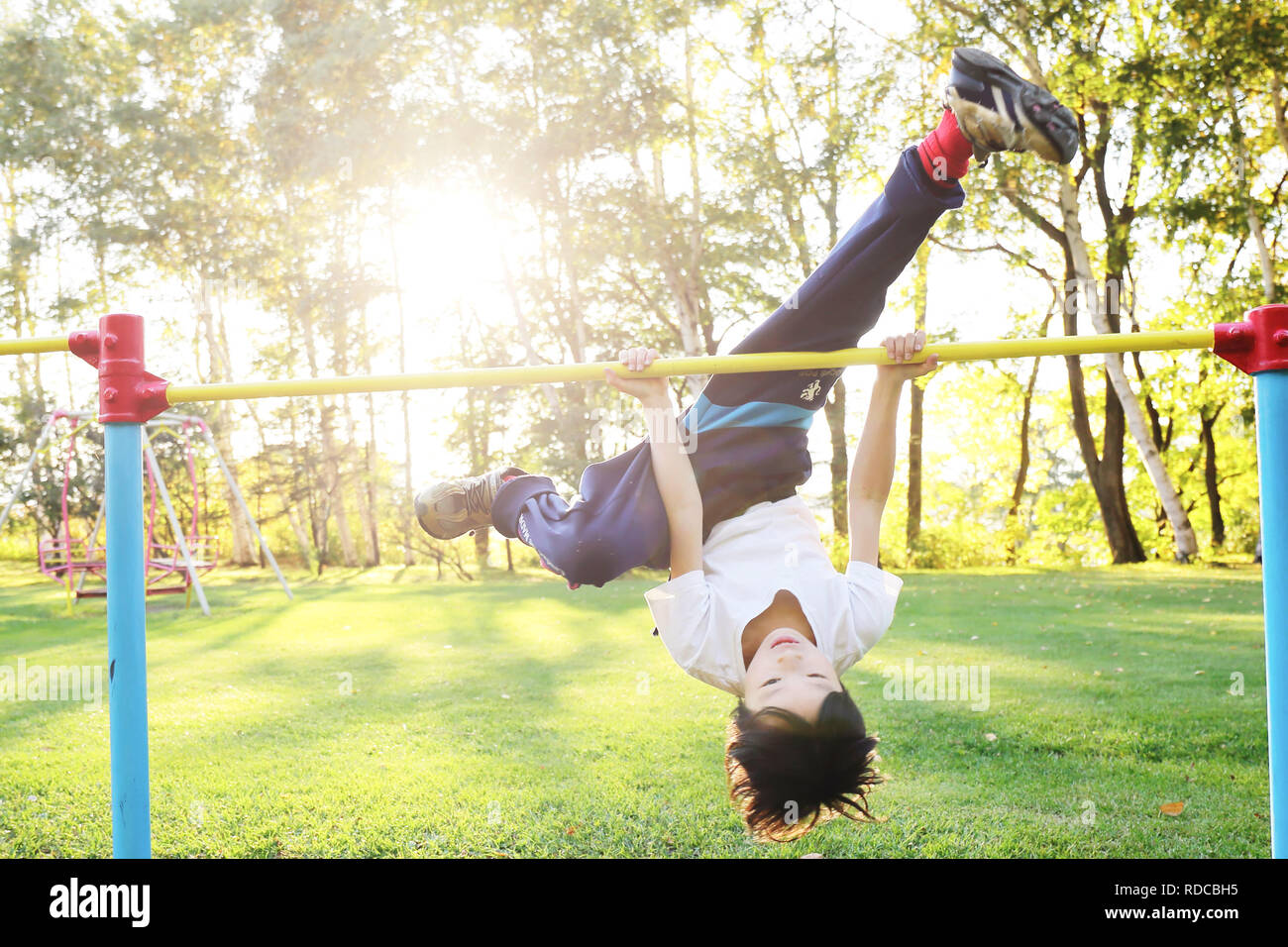 Kid Playing on Horizontal Bar Stock Photo - Alamy