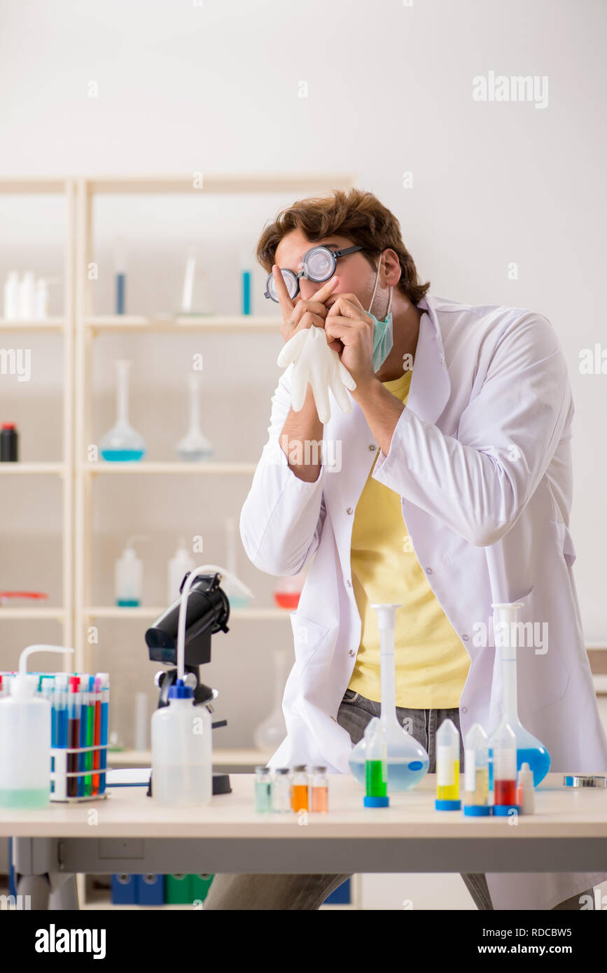 Funny crazy chemist doing experiments and tests Stock Photo - Alamy