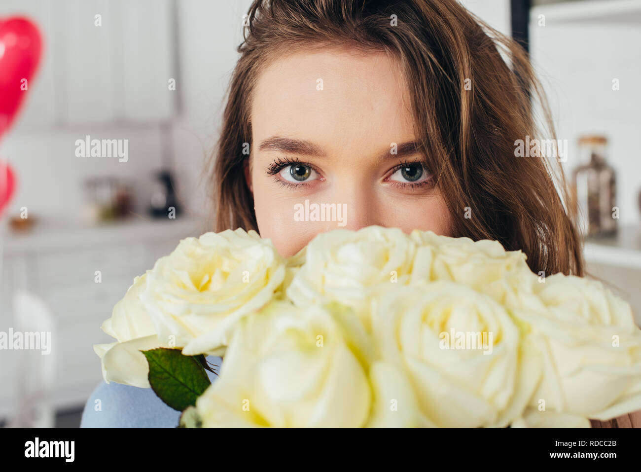 selective focus of a young beautiful girl with obscure face and roses ...