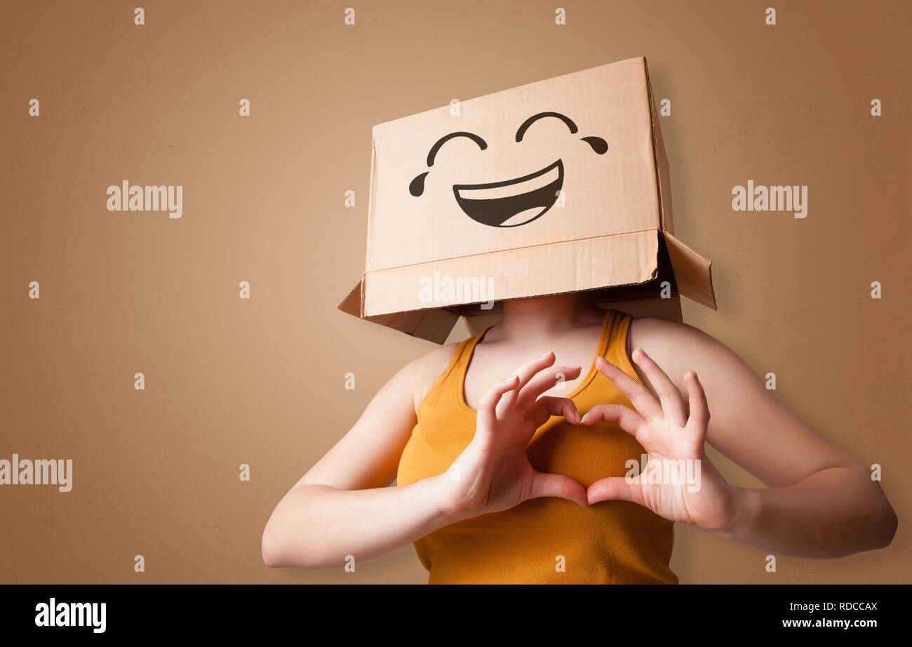 Funny woman wearing cardboard box on her head with smiley face Stock ...