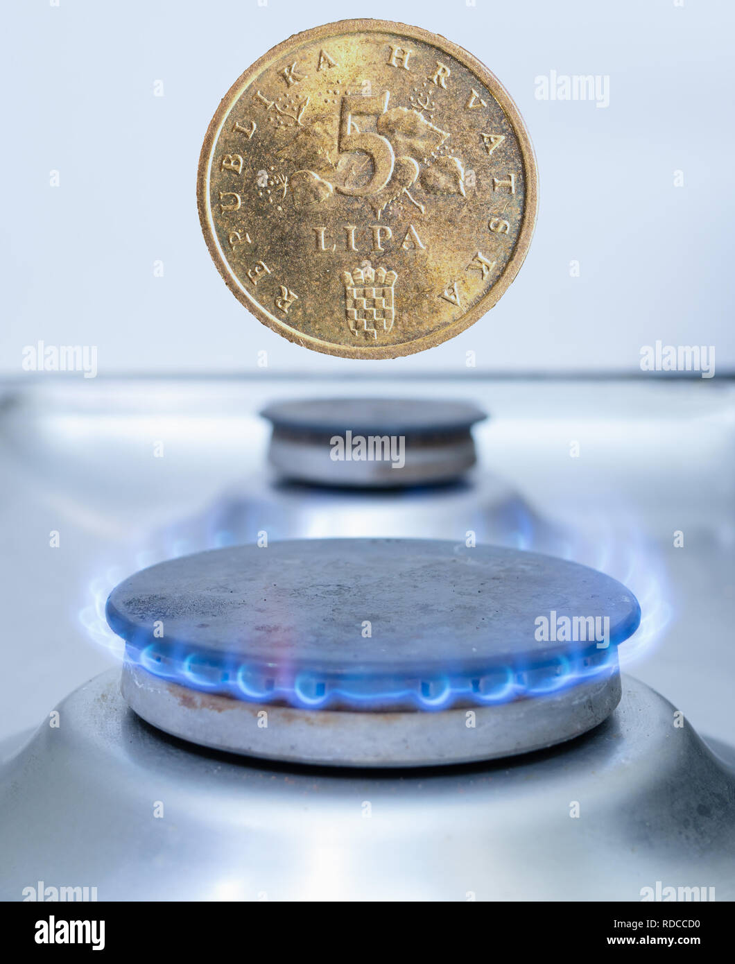 one Croatia coin lipa kuna over gas burner. utility costs in Europe ...