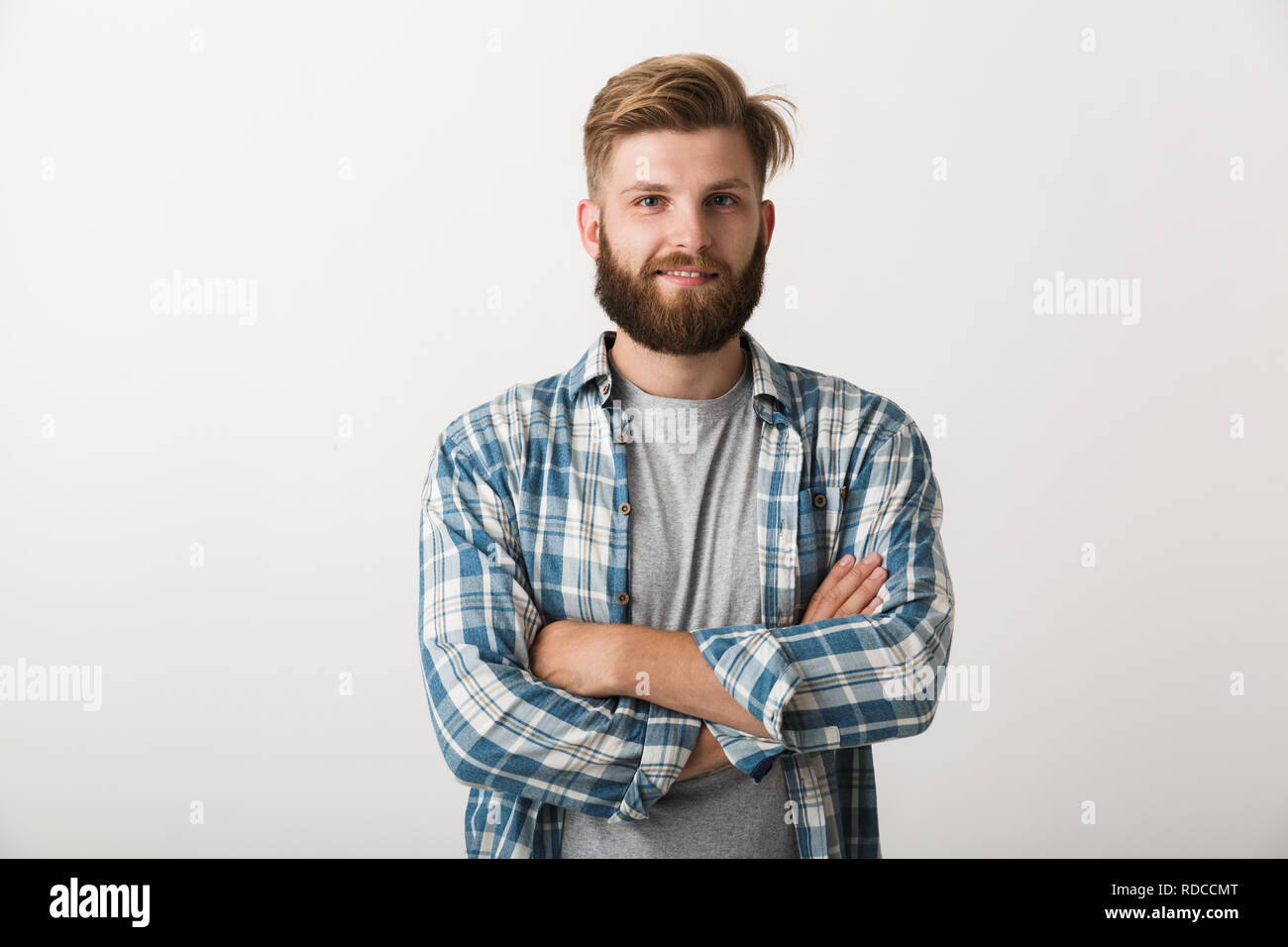 Happy bearded man dressed in plaid shirt standing isolated over white ...