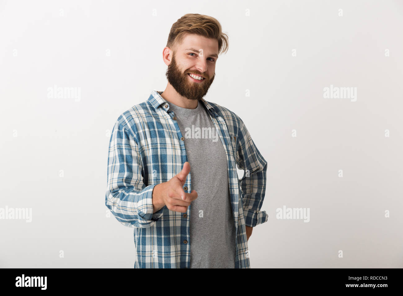 Happy bearded man dressed in plaid shirt standing isolated over white ...