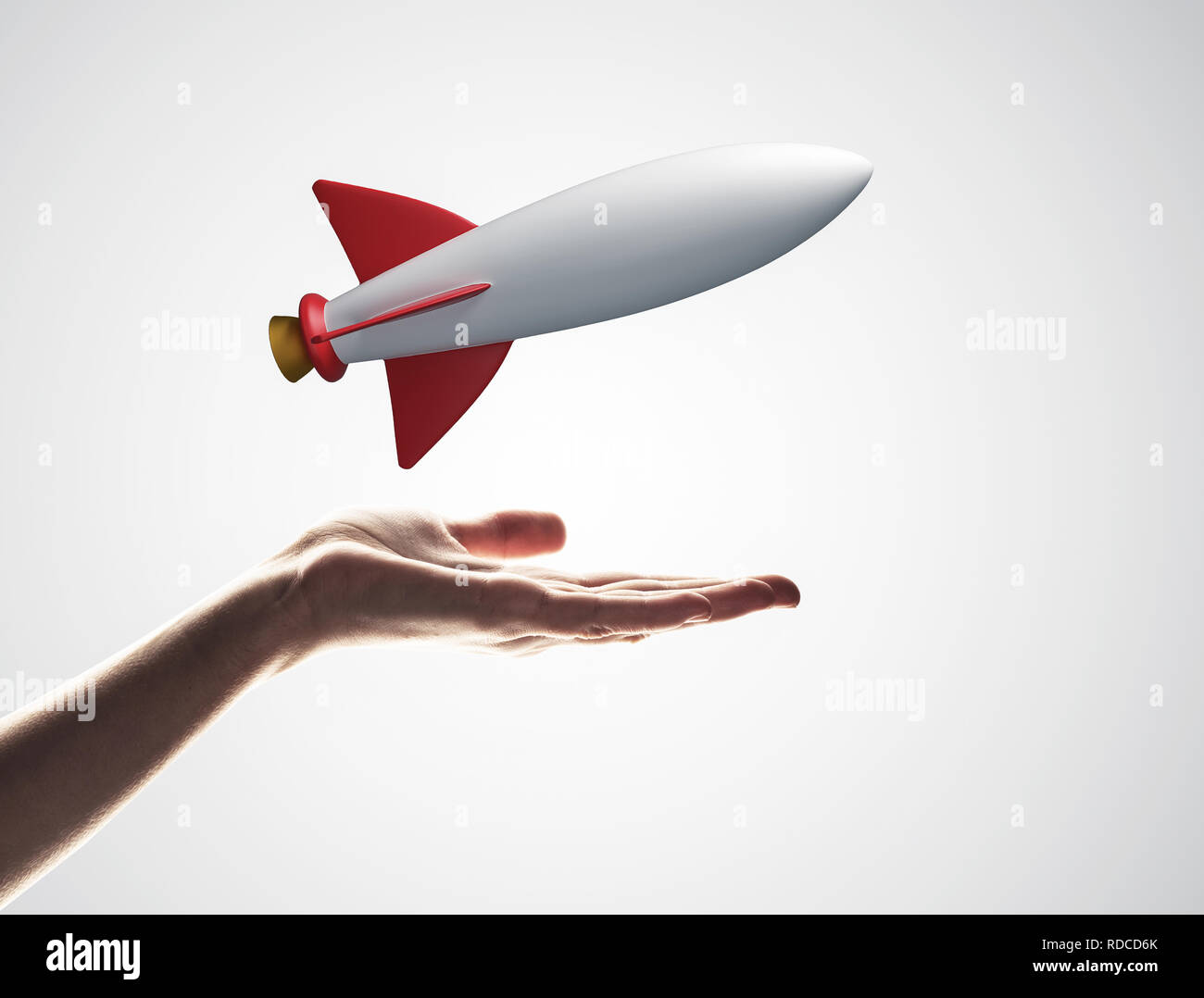 Close up of male hand holding in palm missile rocket on white ...