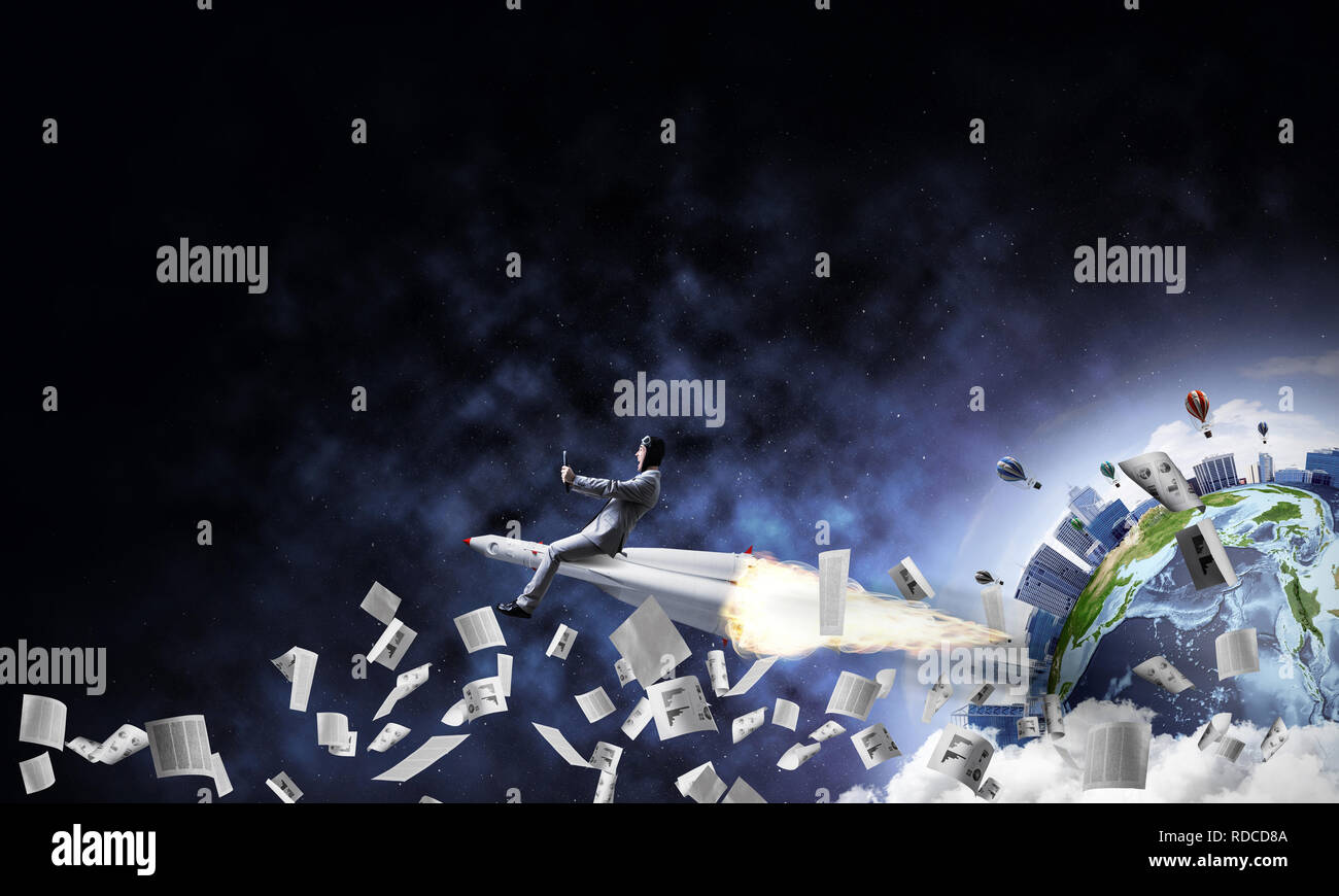 Conceptual image of young businessman in suit flying on rocket among ...