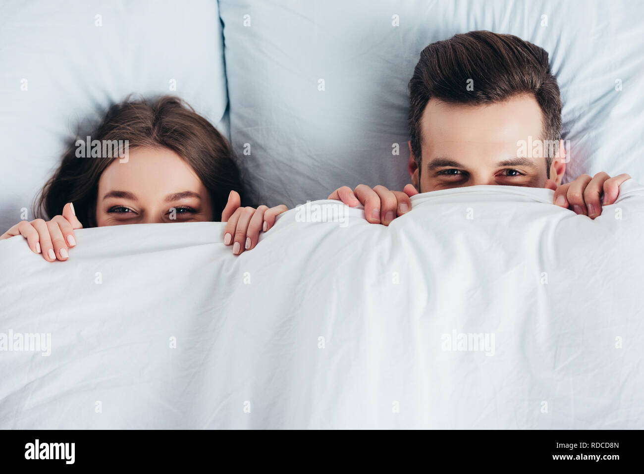 Woman hiding under blanket hi-res stock photography and images - Alamy