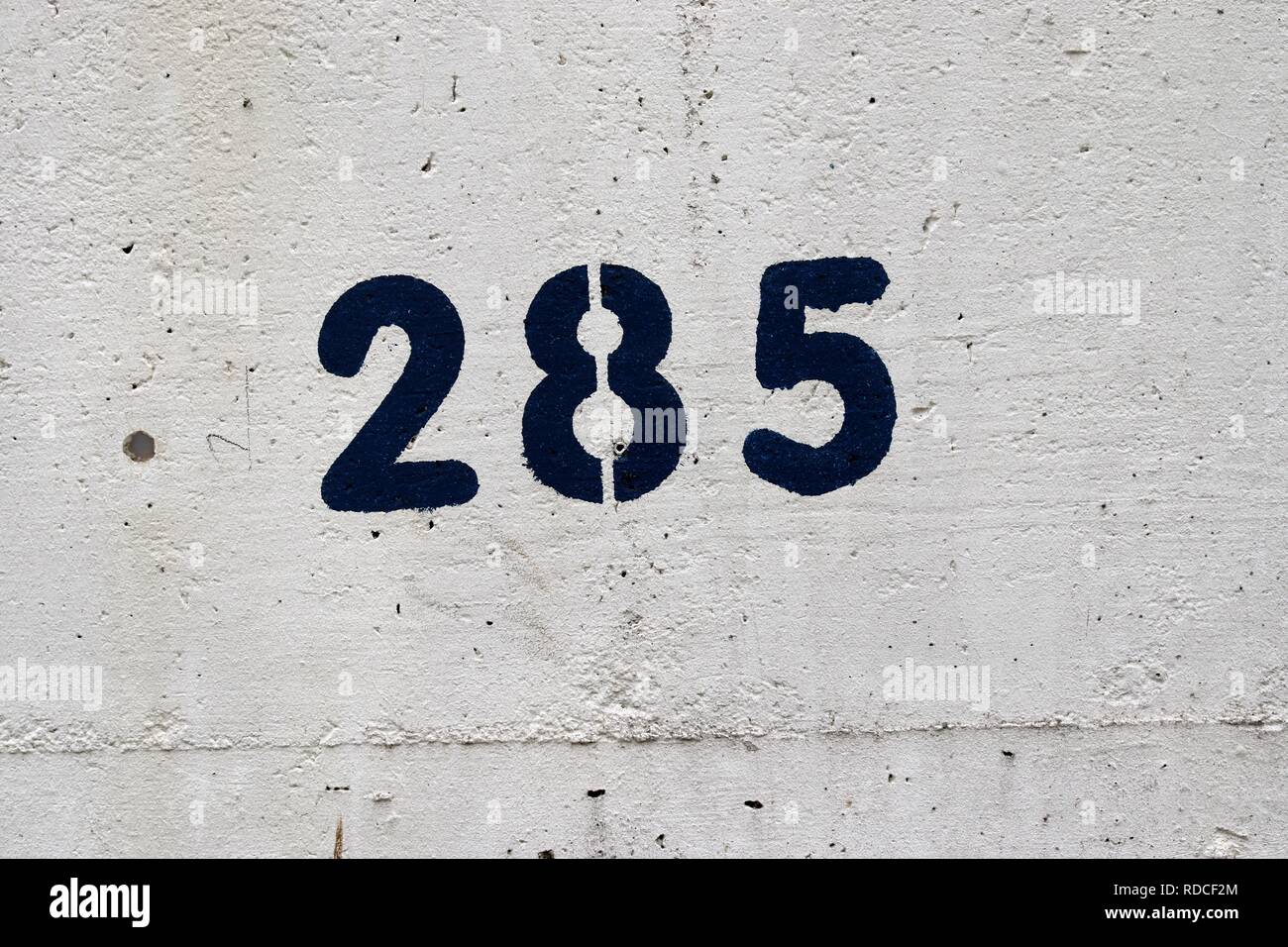 Numbers on a concrete wall Stock Photo - Alamy