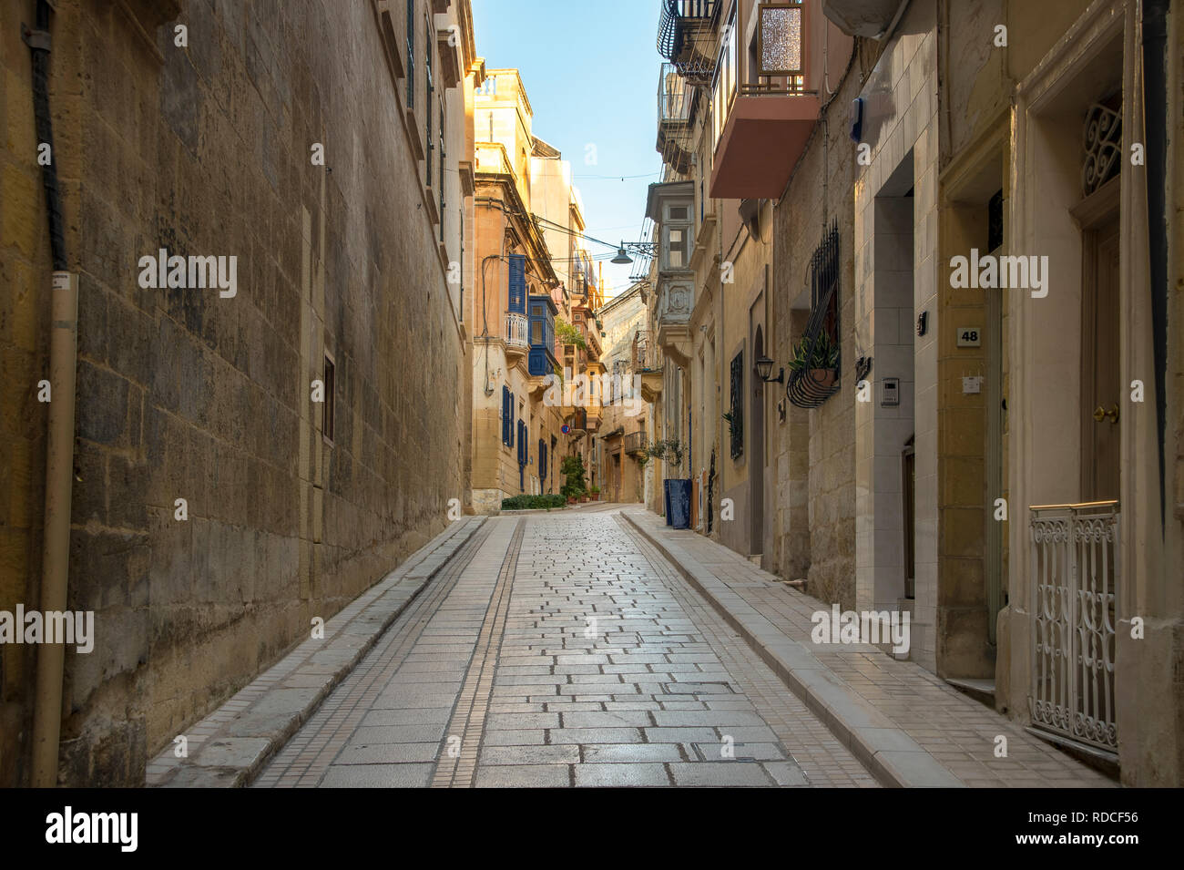 narrow streets of Vittoriosa, Malta. Traditional limestone buildings ...