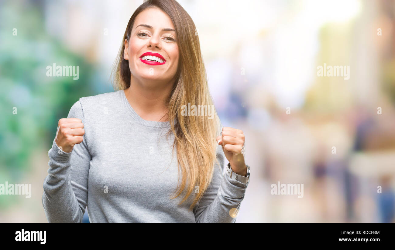 Young beautiful worker business woman over isolated background excited ...