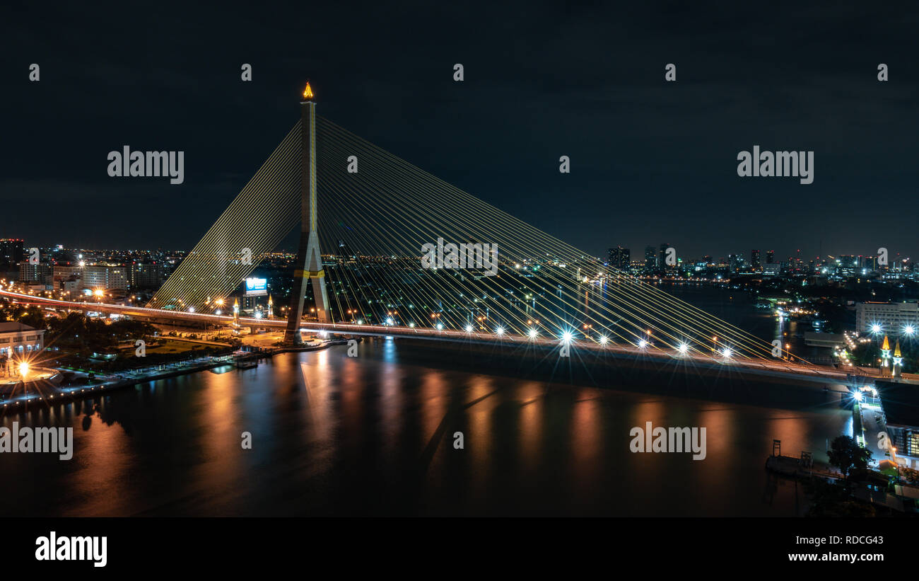 Rama VIII (Rama 8) Bridge at night in Bangkok and Chaopraya river ...