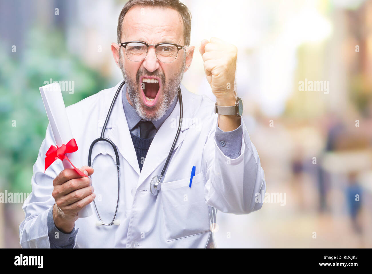 Middle age senior hoary doctor man holding degree certificate over ...