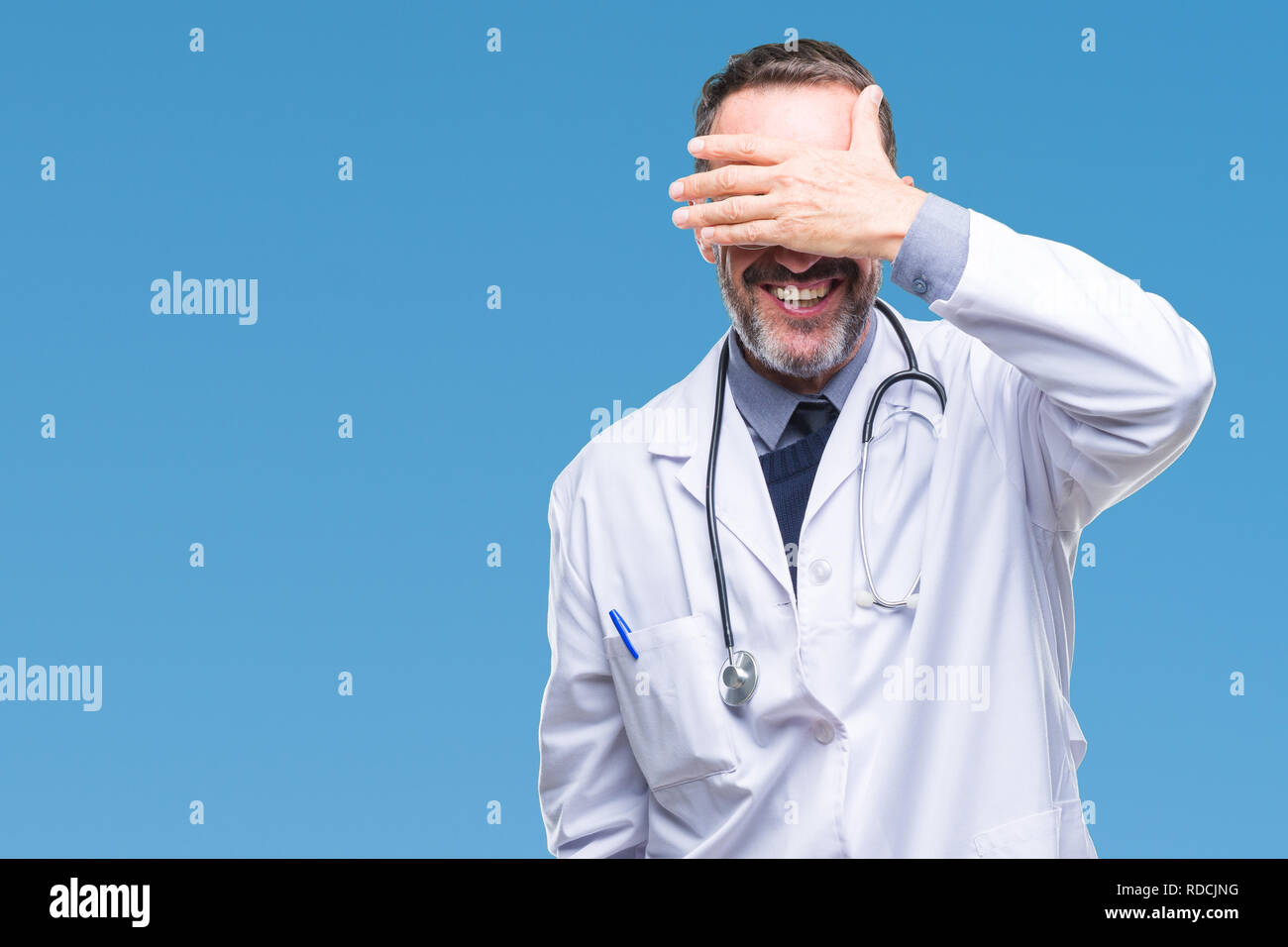 Middle age senior hoary doctor man wearing medical uniform isolated ...