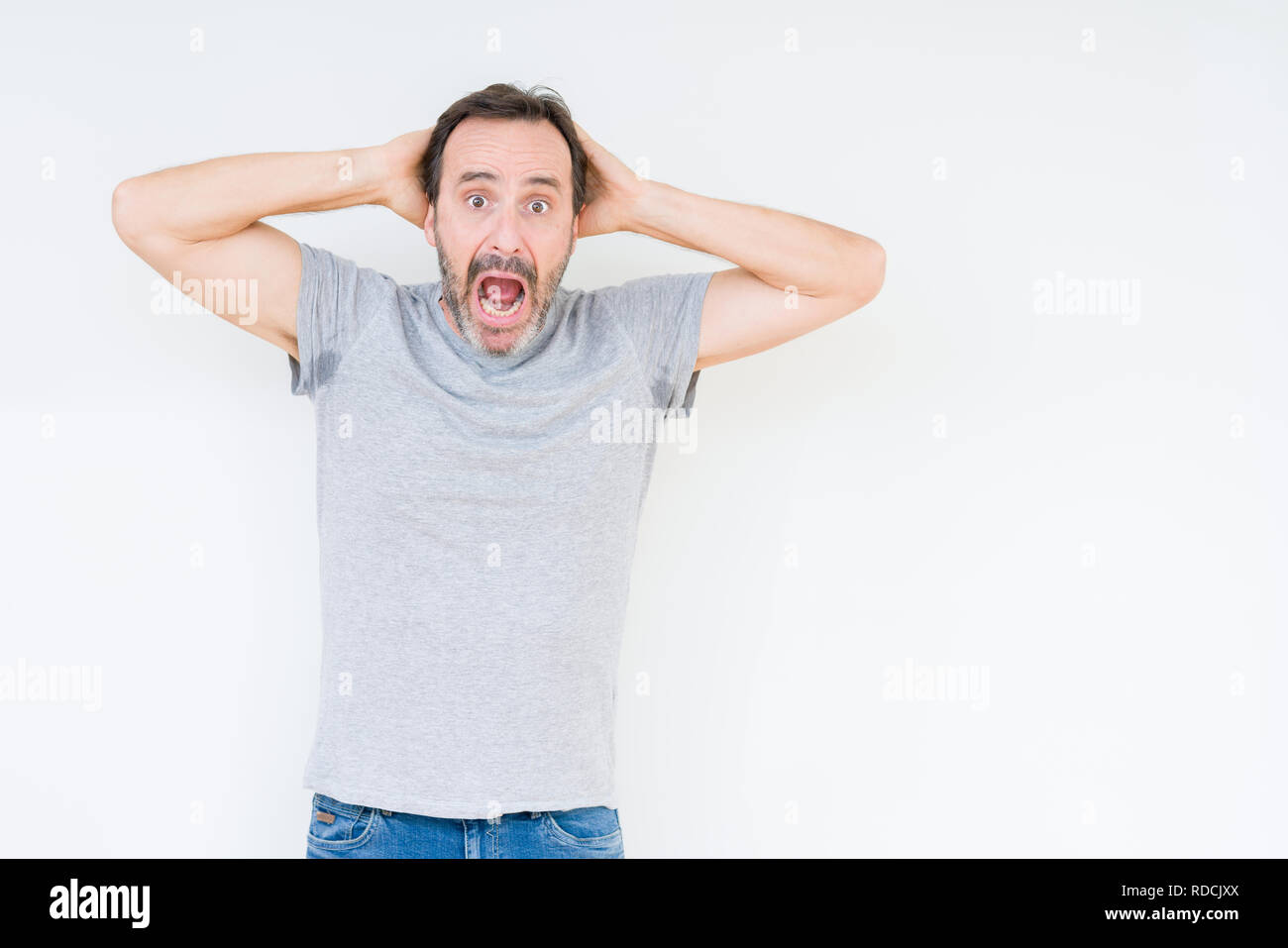 Handsome senior man over isolated background Crazy and scared with ...