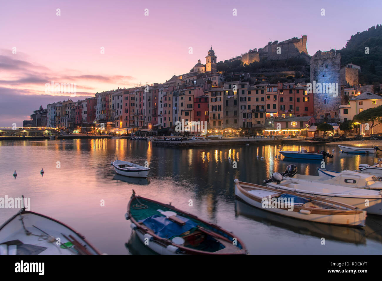 Colorful purple sunset over Portovenere, Italy with reflections of the ...