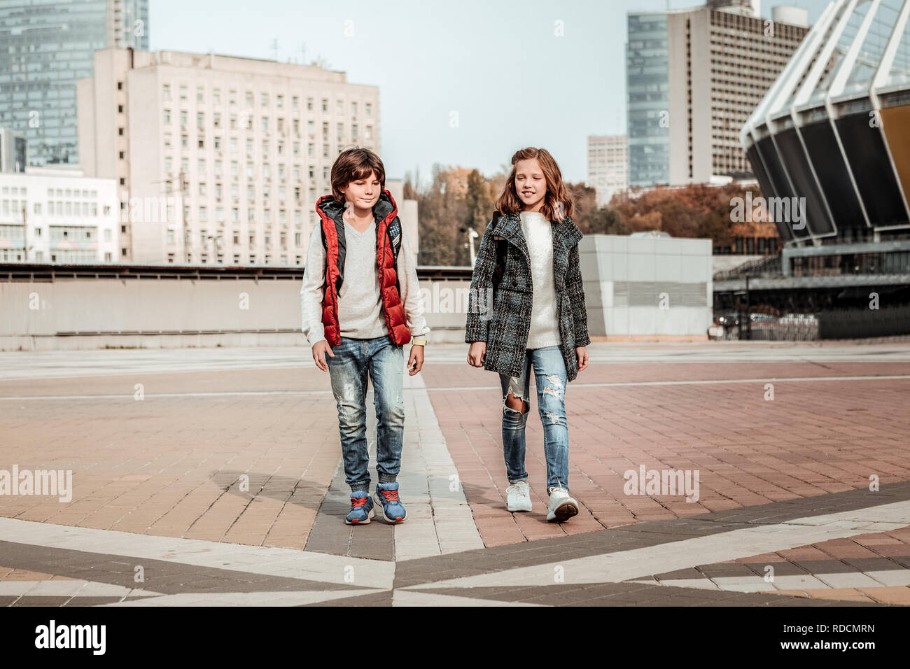 Boy and a girl walking home together after school Stock Photo - Alamy
