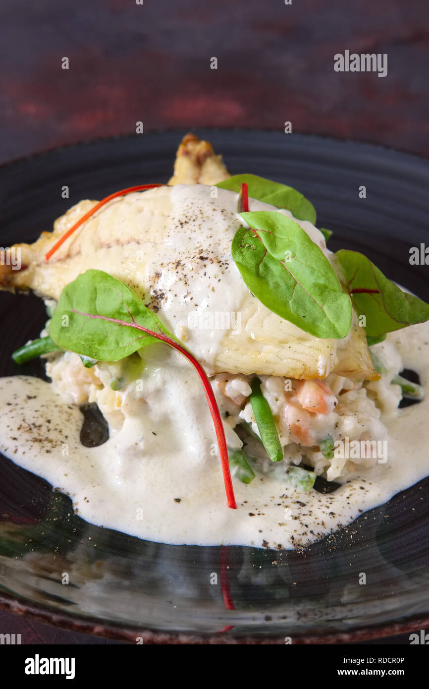 Fried fillet of white fish with rice and green beans decorated with ...