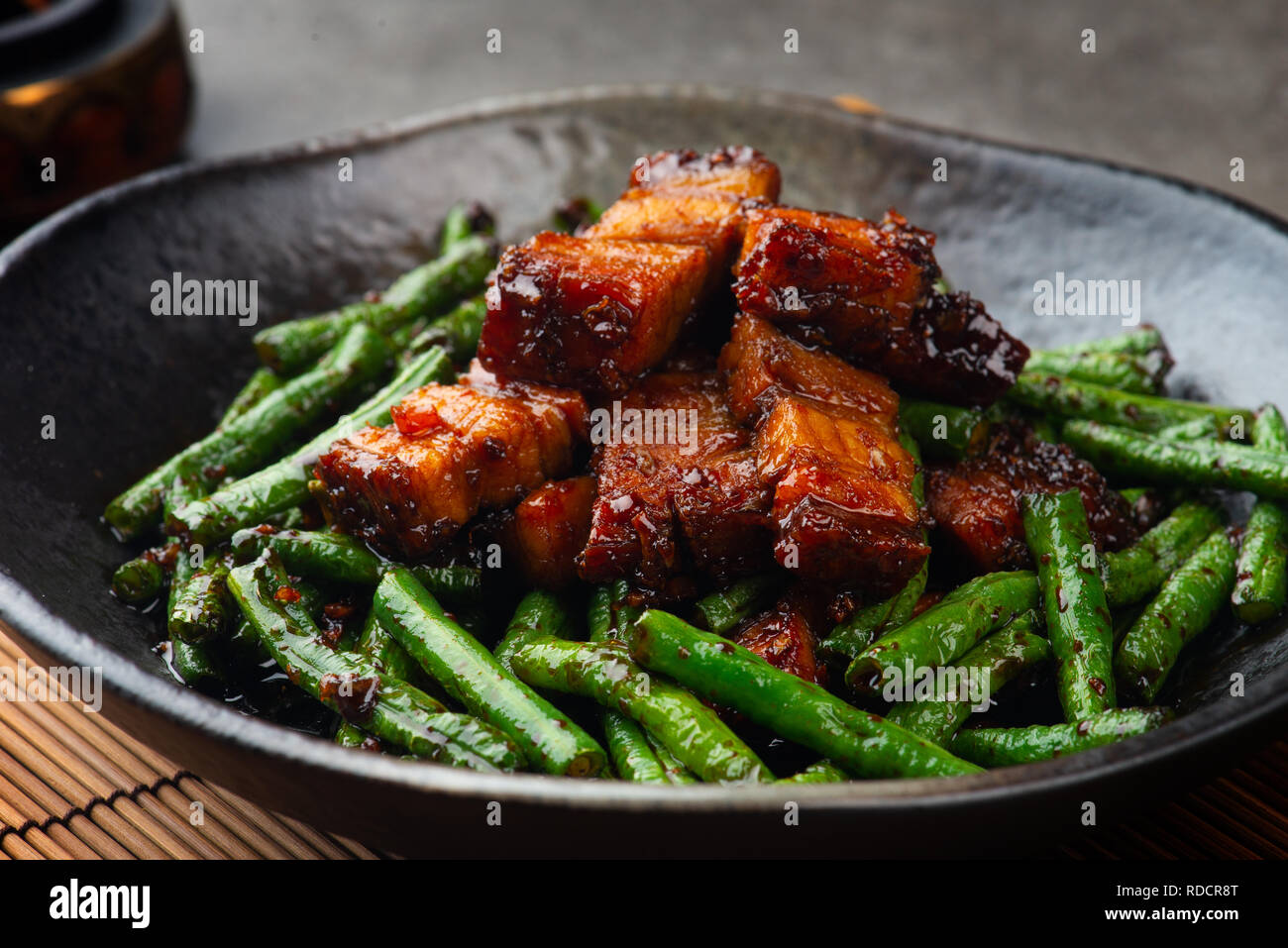 Spicy stir-fried green beans with pork belly Stock Photo - Alamy