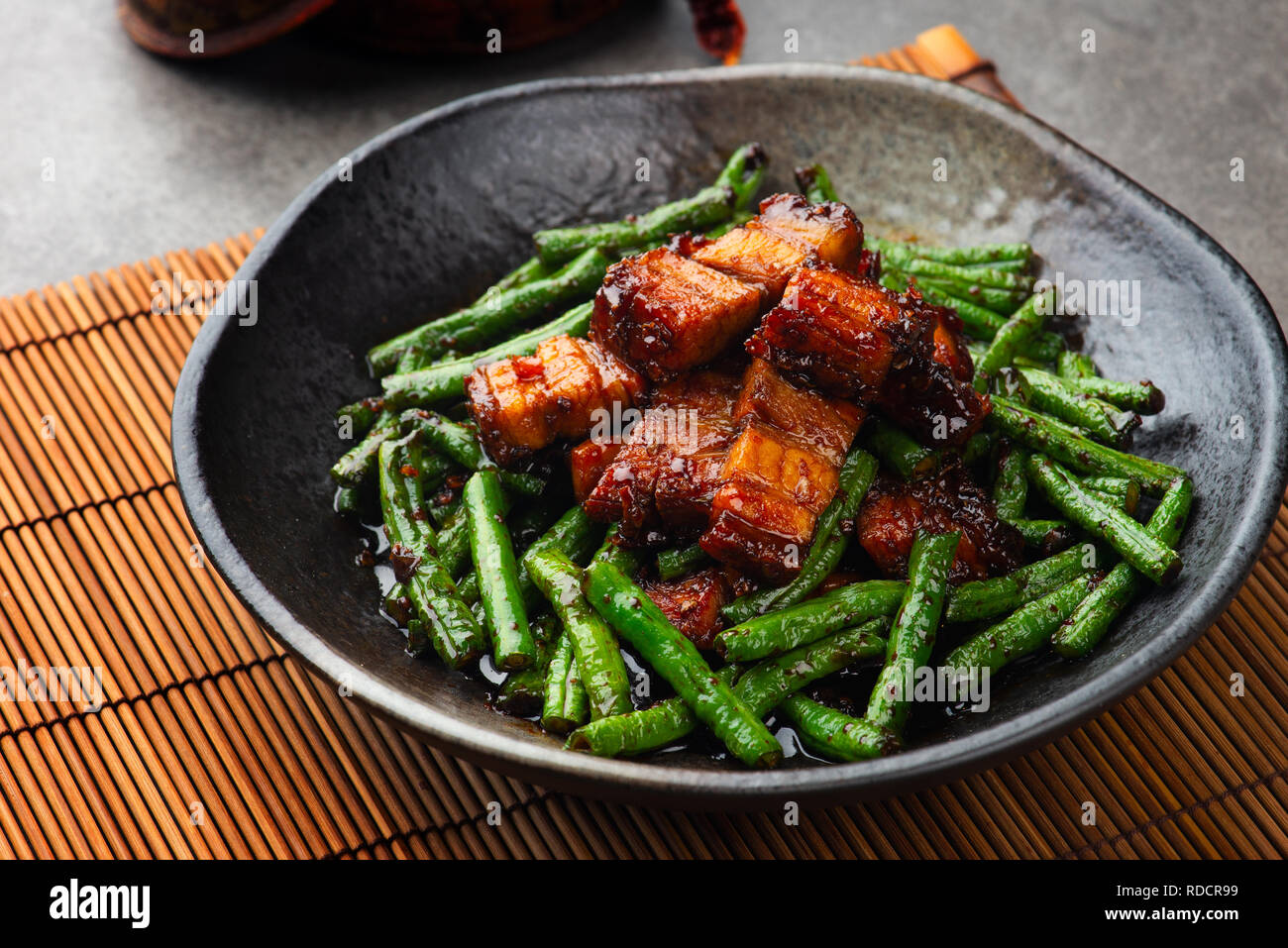 Spicy stir-fried green beans with pork belly Stock Photo - Alamy