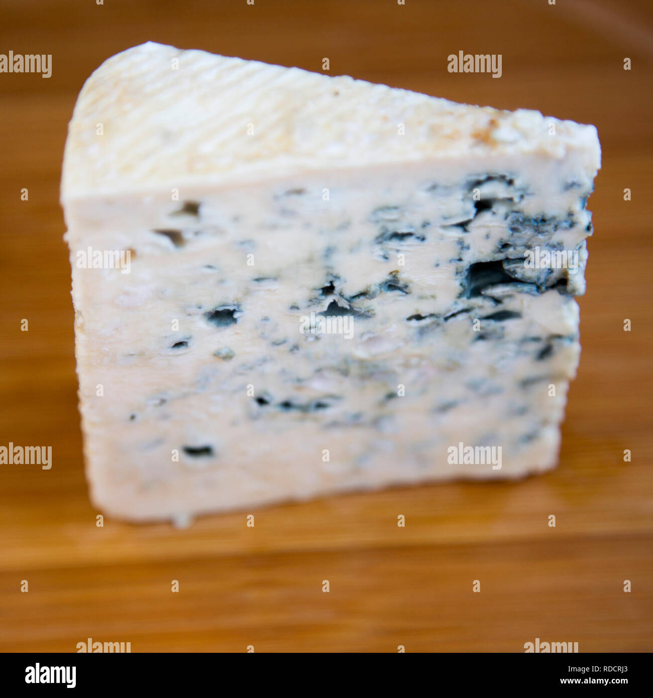 Blue cheese on bamboo board, side view. Close-up Stock Photo - Alamy