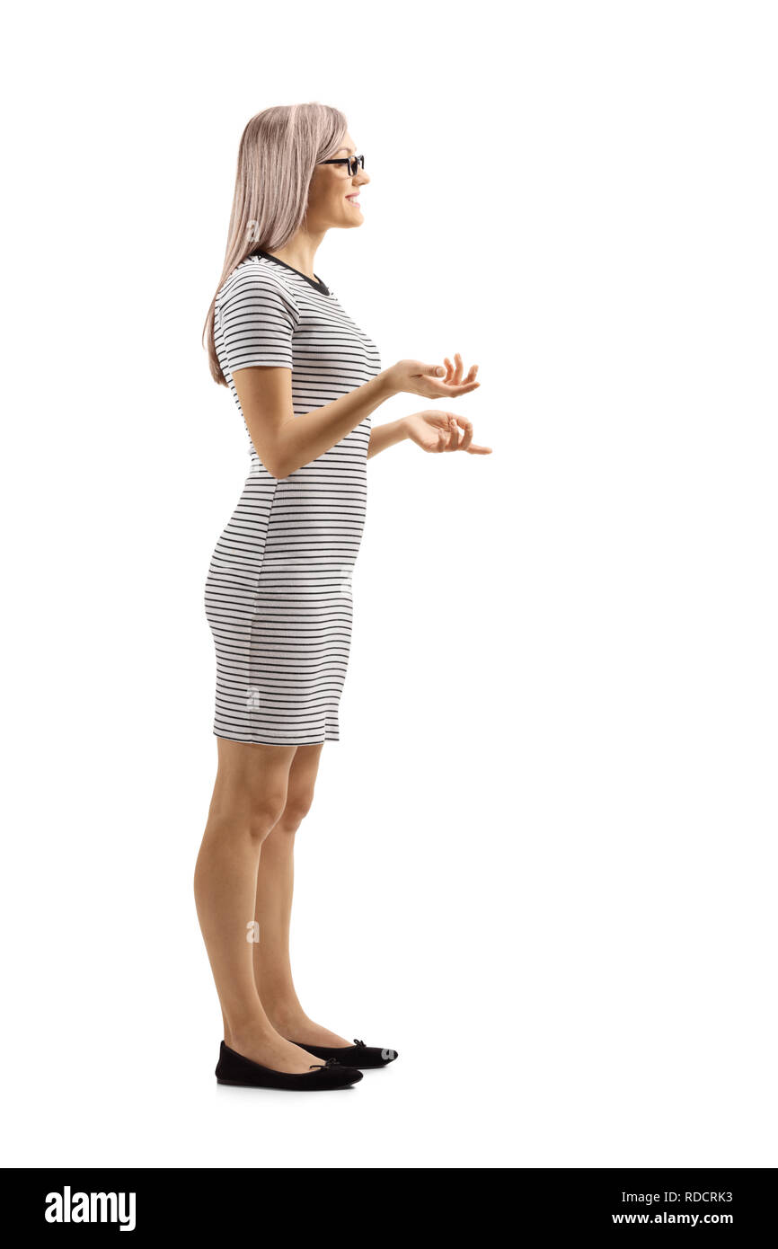 Full length shot of a young blond woman gesturing conversation isolated ...