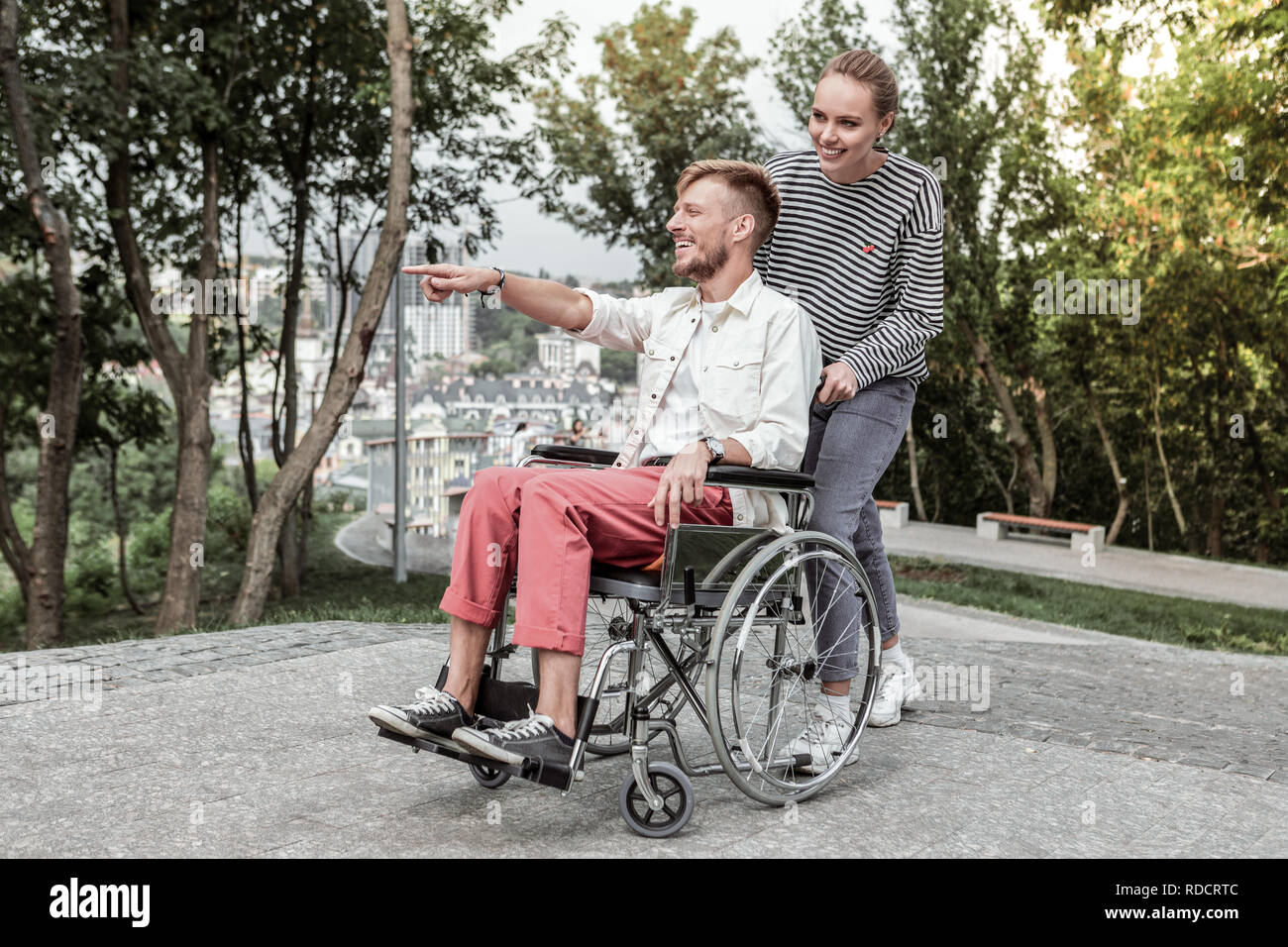 Positive delighted immobile man pointing at correct direction Stock ...