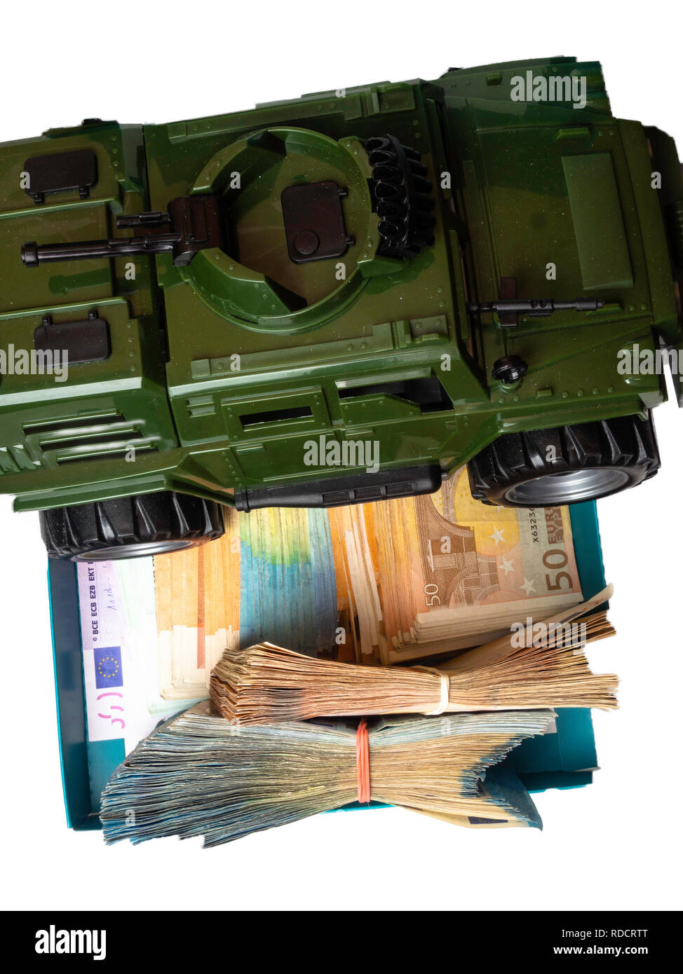 tank toy placed on euro banknotes pile. business, economy war. new ...