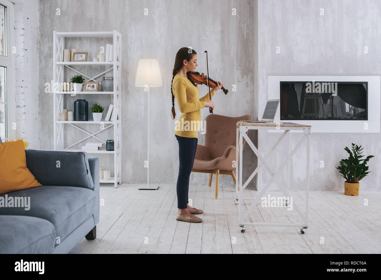 Nice young girl standing in the middle of the room Stock Photo - Alamy