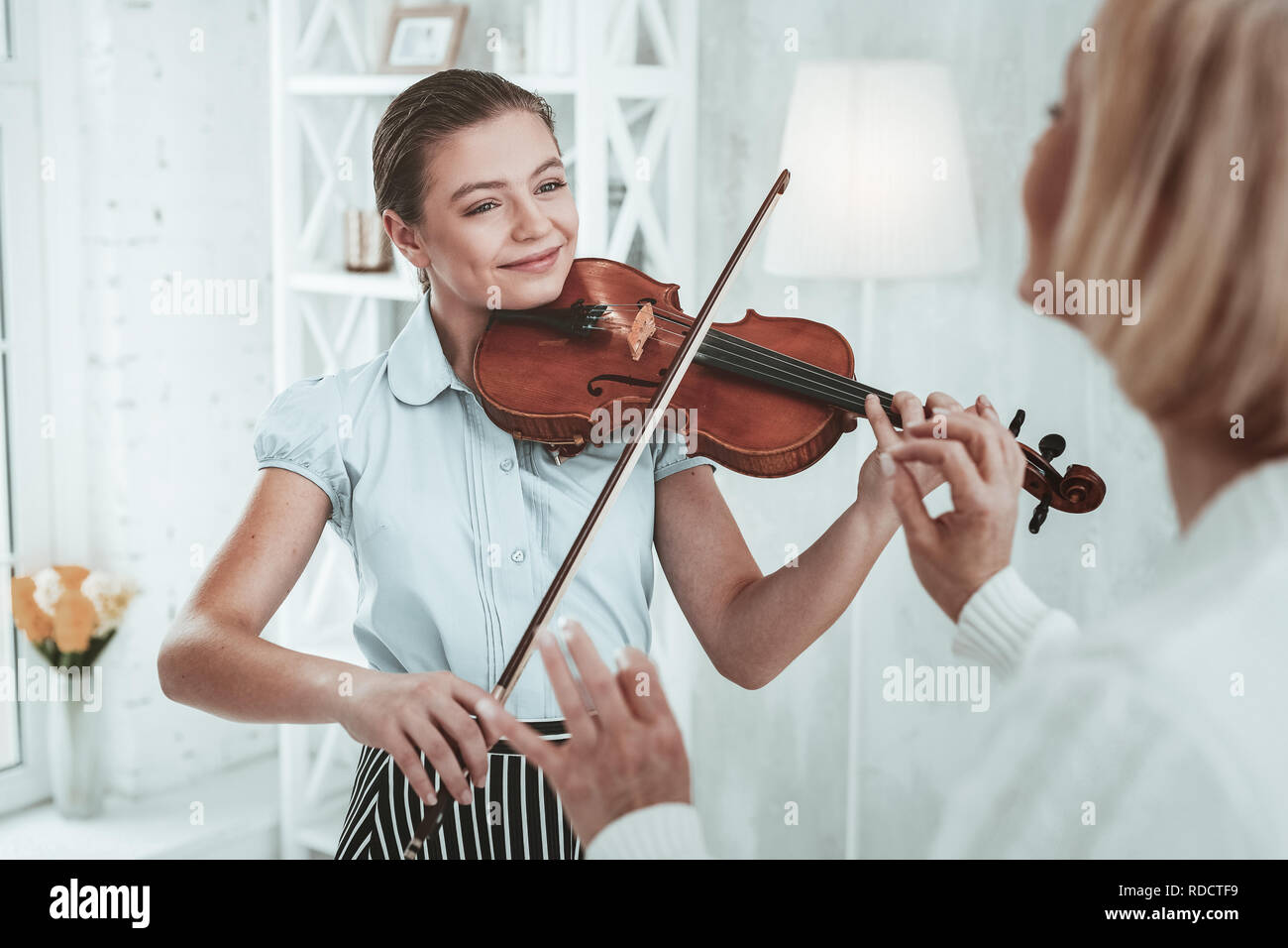 Cheerful happy nice girl having musical skills Stock Photo - Alamy
