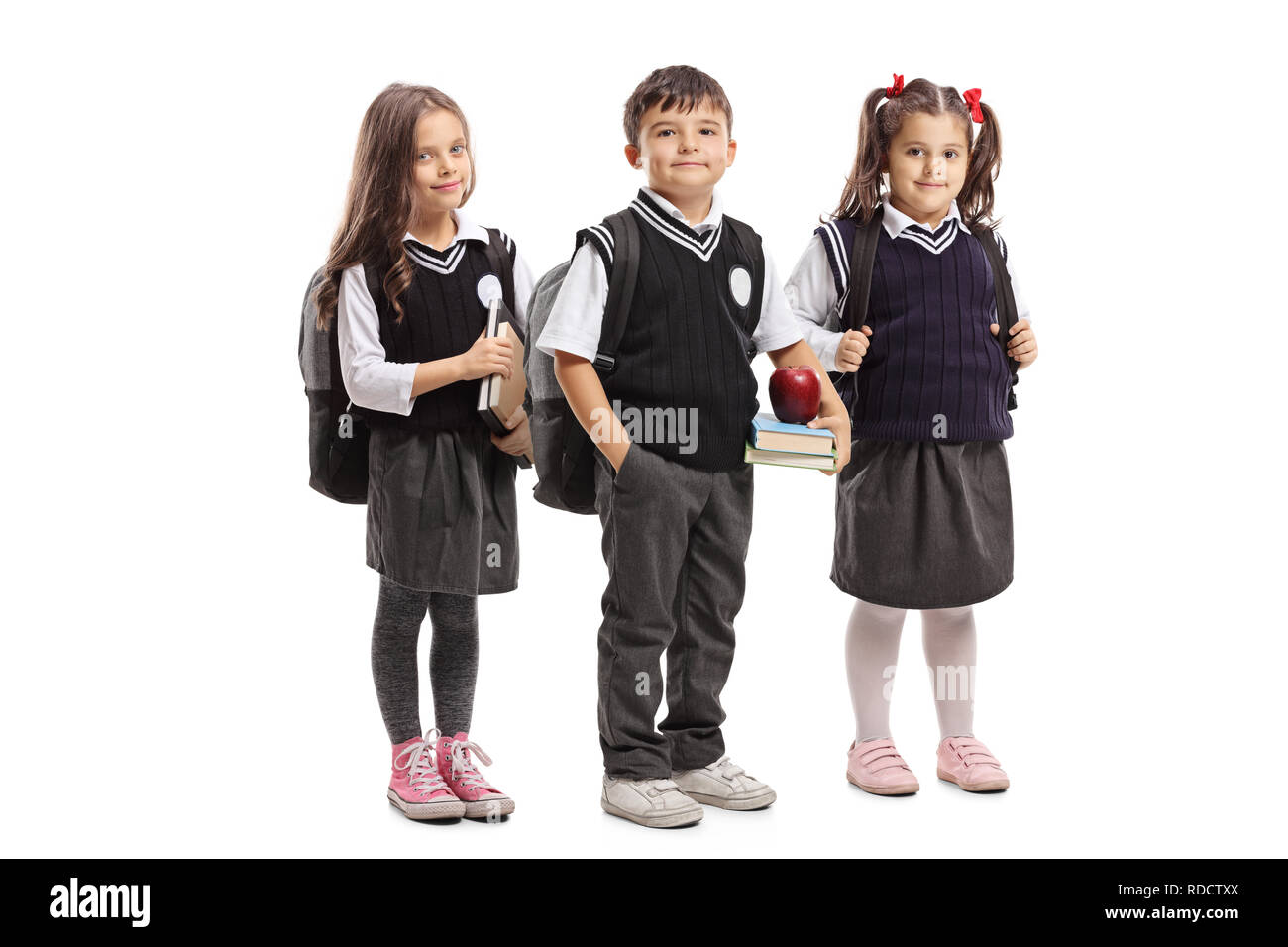 Full length portrait of schoolchildren in a uniform posing isolated on ...