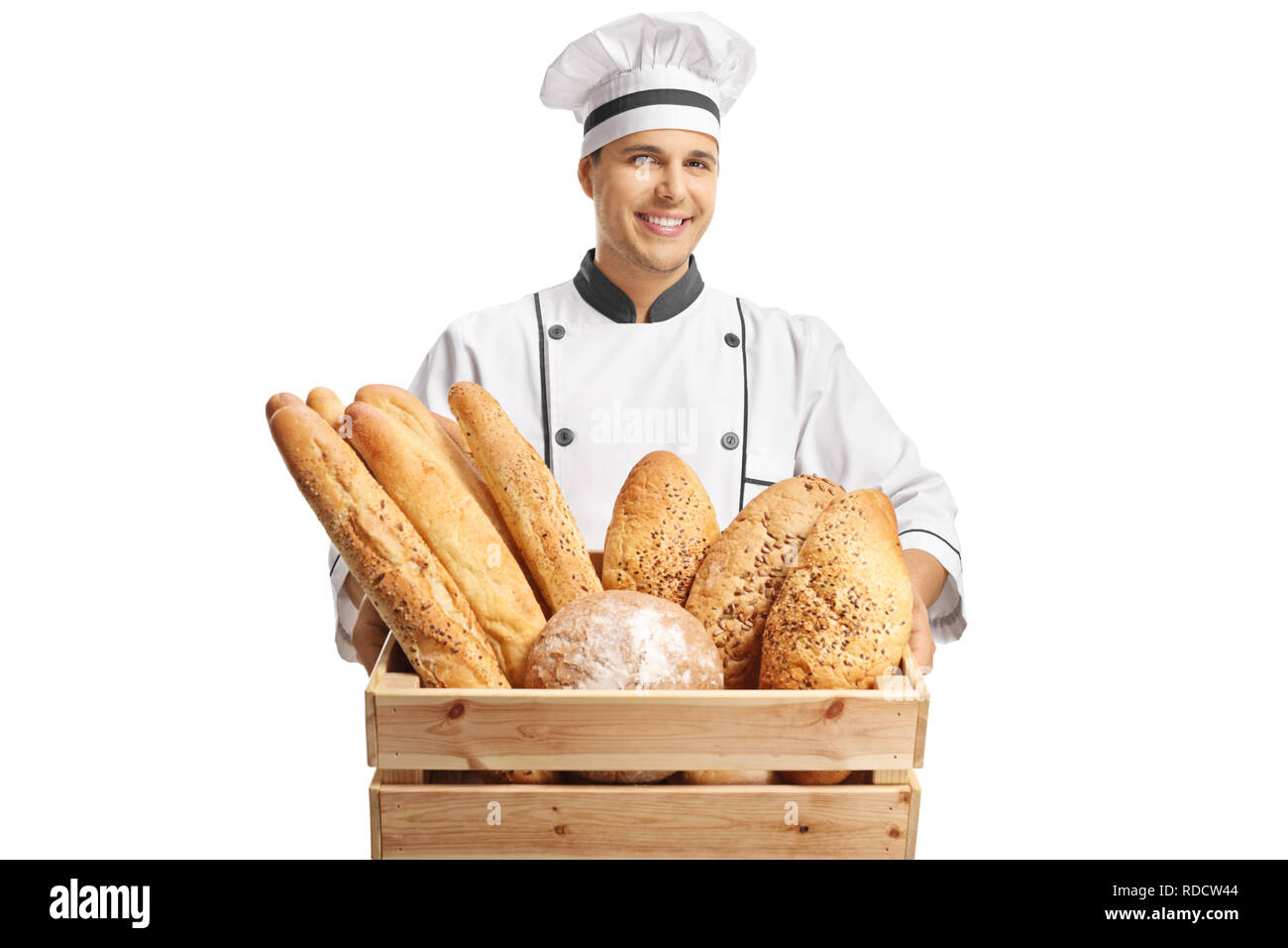 Young male baker holding a box with different types of bread isolated ...