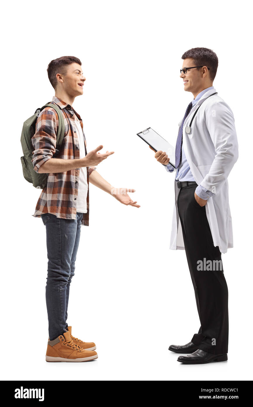 Full length shot of a teenage male student talking to a male doctor ...
