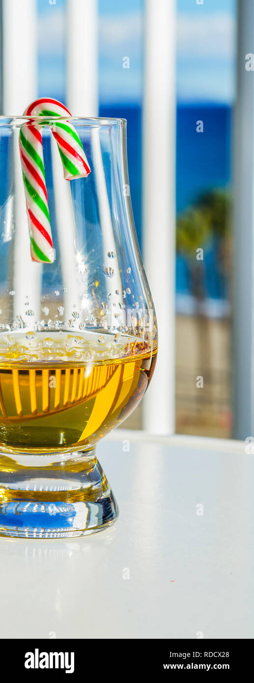 single malt whiskey glass with candy cane, the symbol of Christmas ...
