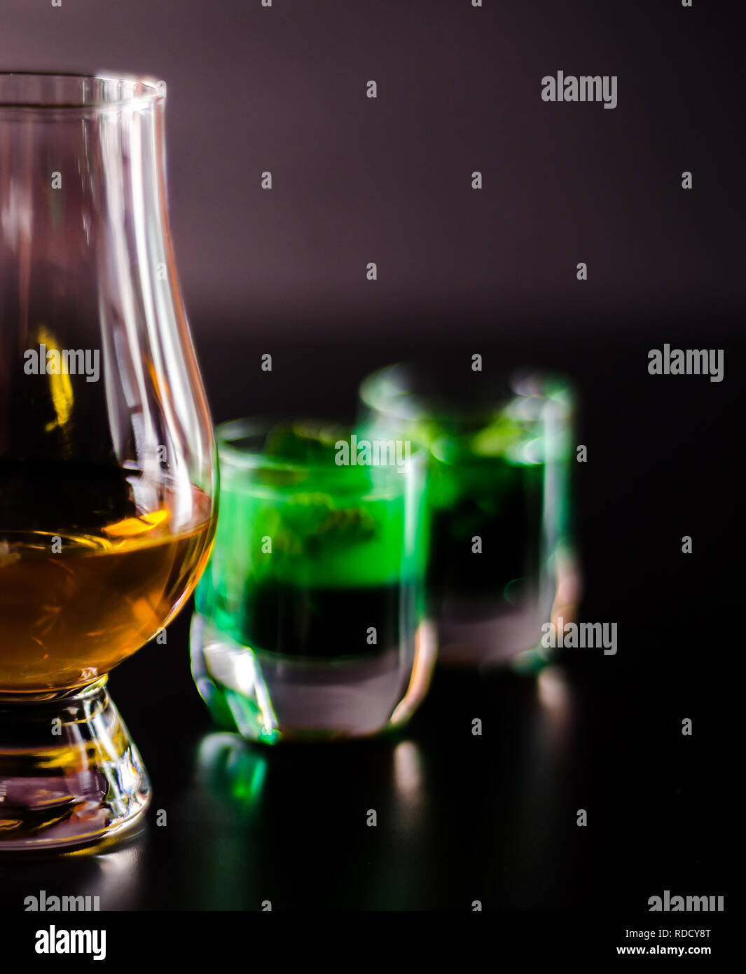 single malt whiskey in a glass and green mint liqueur, refreshing set ...