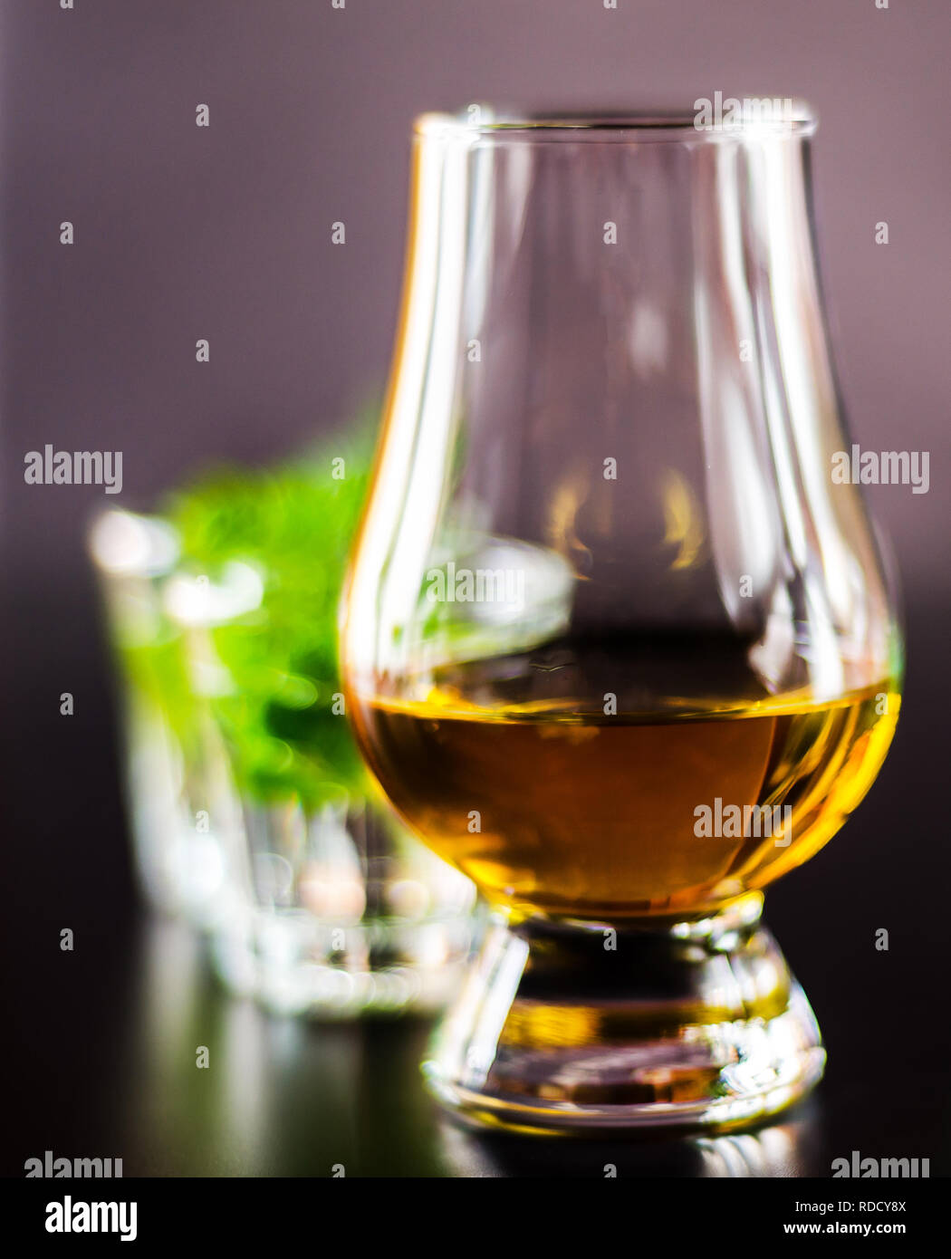 single malt whiskey in a glass and green mint liqueur, refreshing set ...