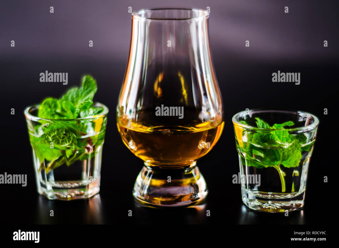 single malt whiskey in a glass and green mint liqueur, refreshing set ...