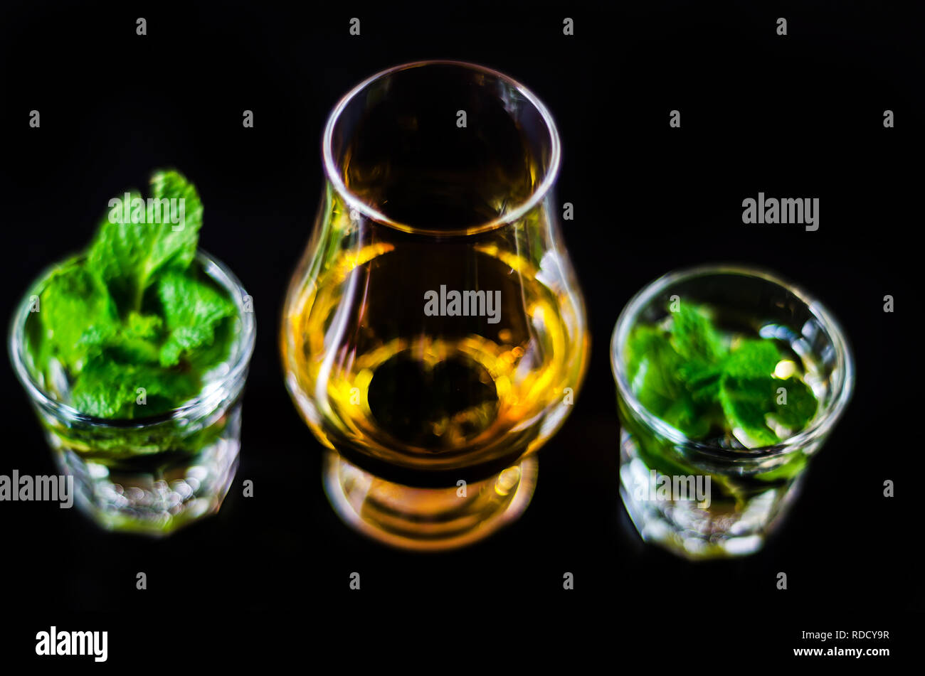 single malt whiskey in a glass and green mint liqueur, refreshing set ...