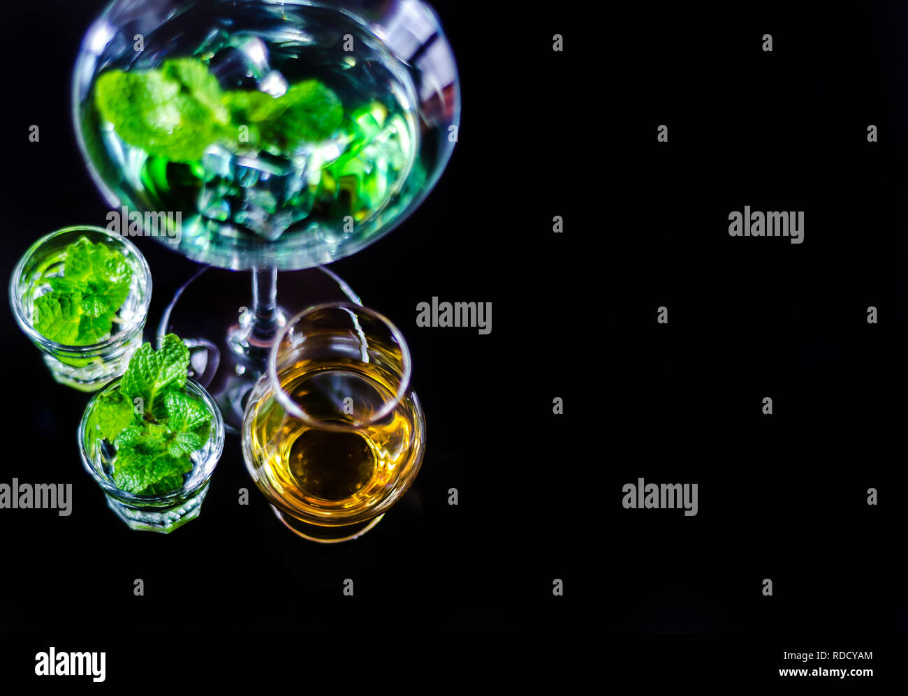 single malt whiskey in a glass and green mint liqueur, refreshing set ...