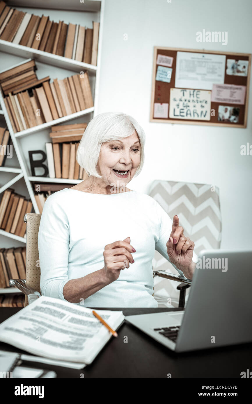 Beautiful elderly woman staring at screen of her laptop Stock Photo - Alamy