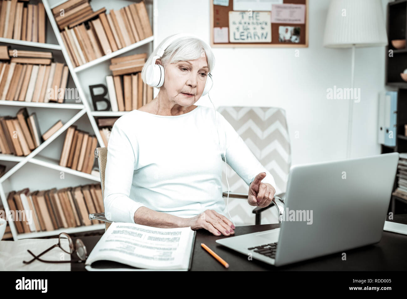 Concentrated mature woman looking at screen of laptop Stock Photo - Alamy