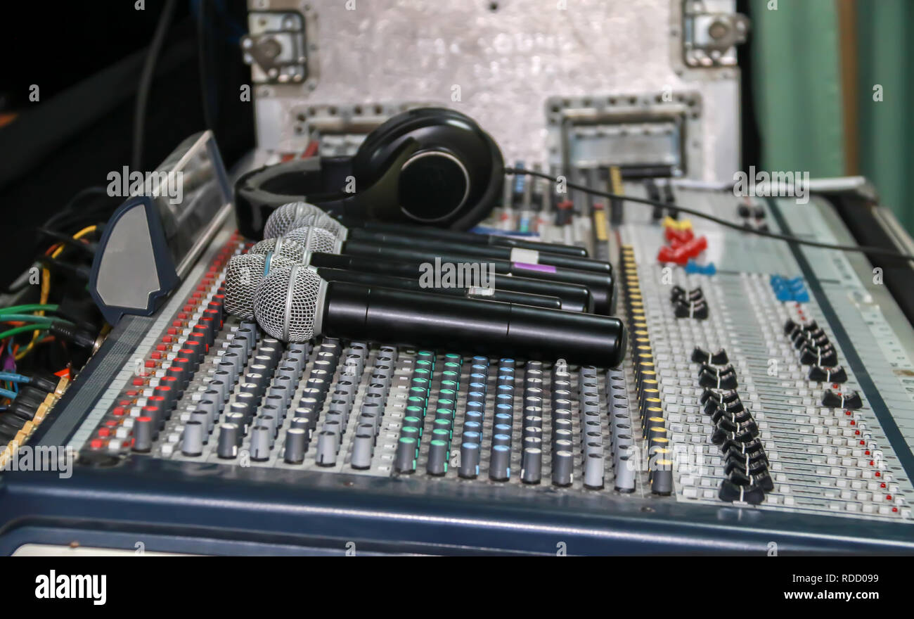 Close up of wireless microphone and headphone put on sound music mixer ...