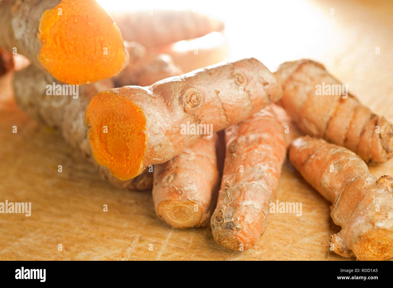 Fresh Tumeric Curcuma Root with Slices on Wooden Stock Photo - Alamy