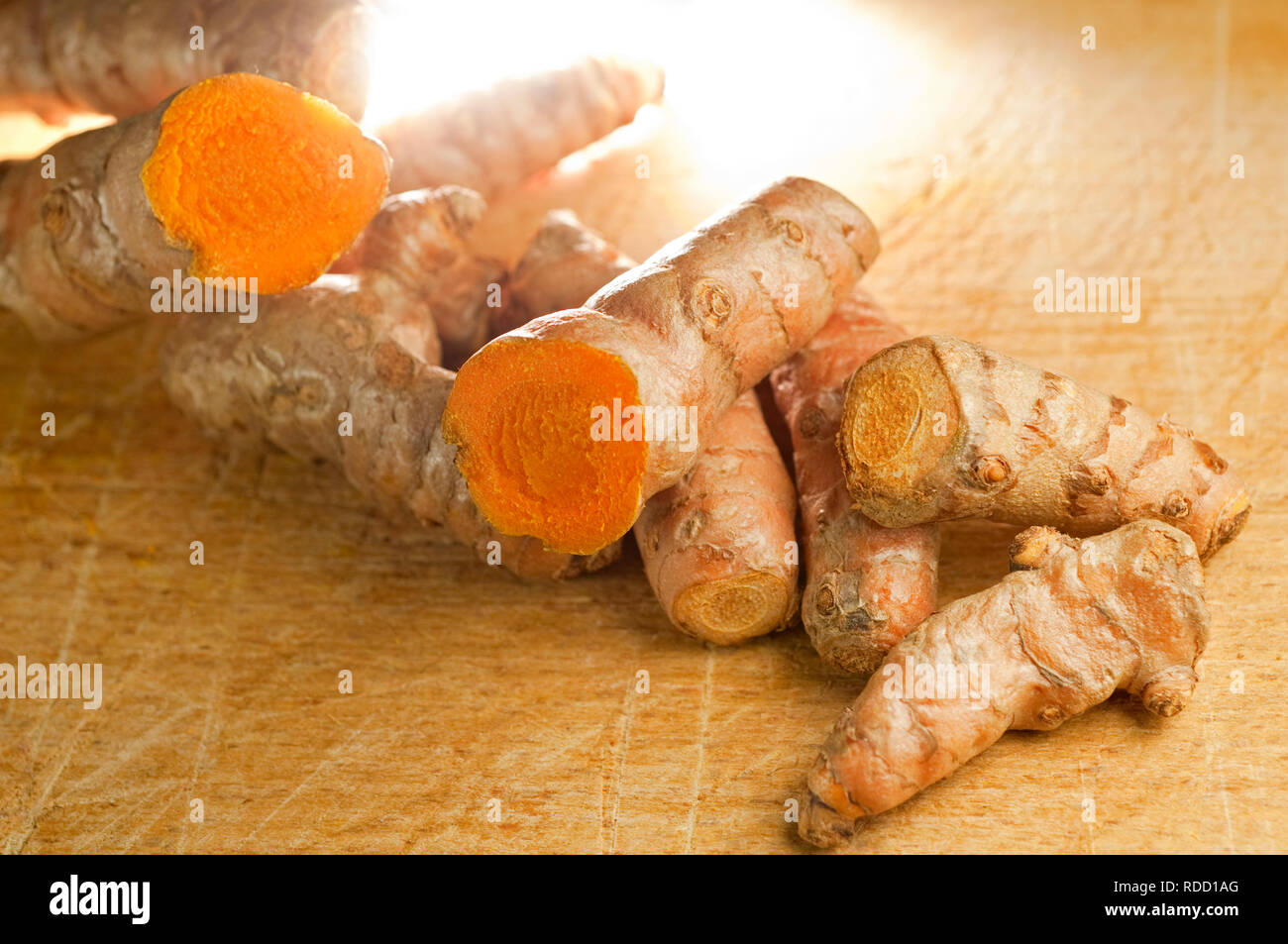 Fresh Tumeric Curcuma Root with Slices on Wooden Stock Photo - Alamy