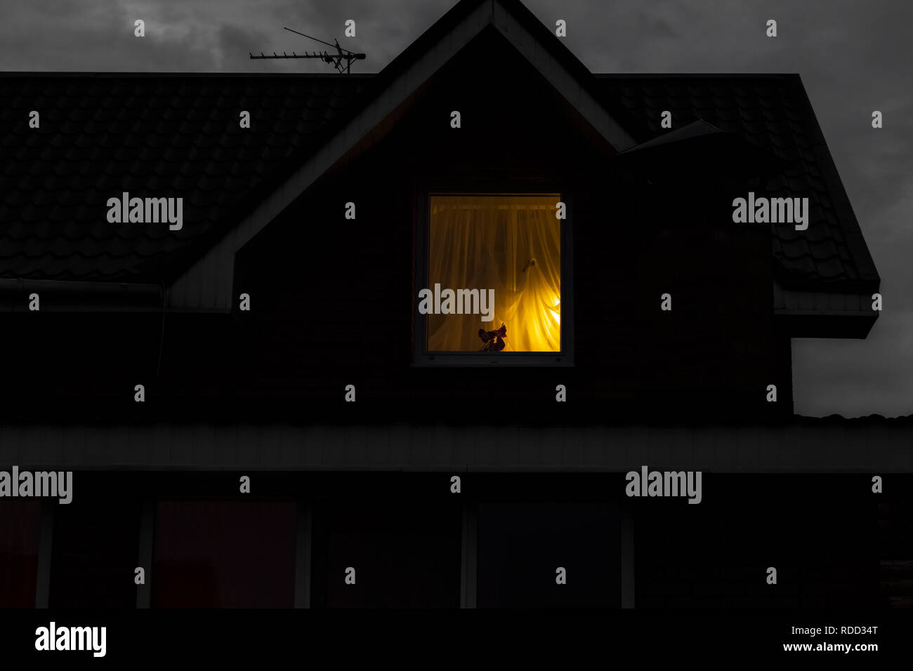 Light from the window of the house in the dark evening time Stock Photo ...