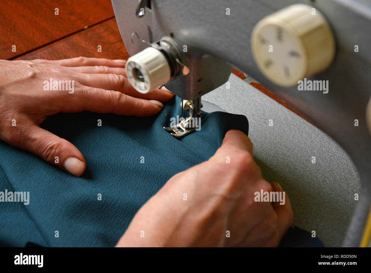 Female tailor working on sewing machine. dress manufacturing industry ...
