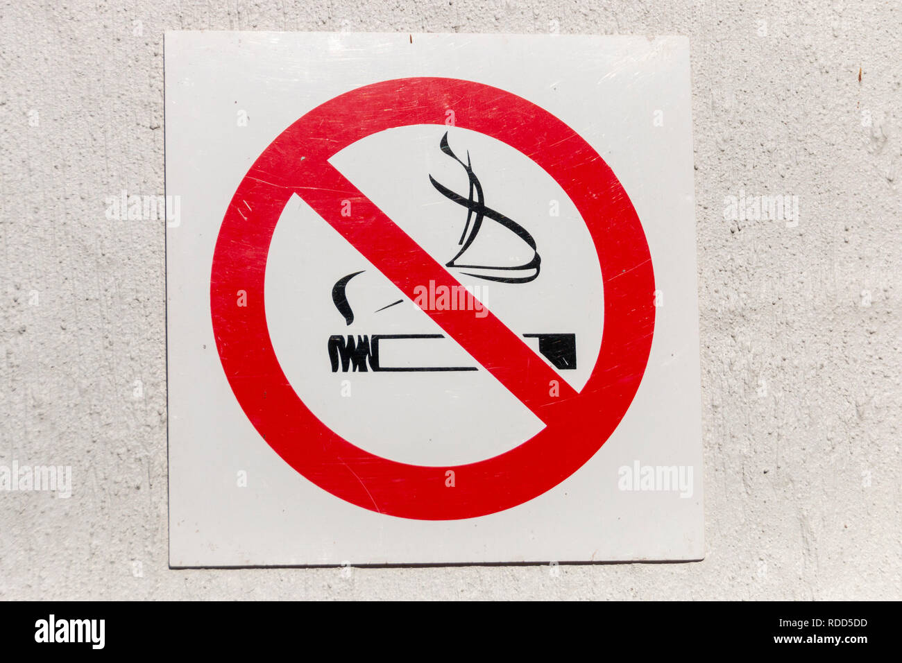 A clsoe up view of an none smoking sign on a isolated white baclground ...